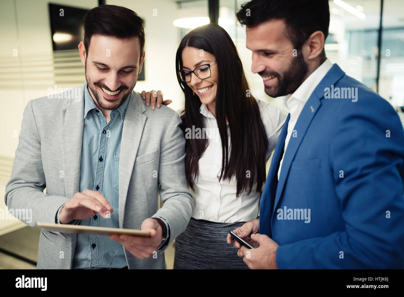 Happy business colleagues casual chat at the office Stock Photo - Alamy