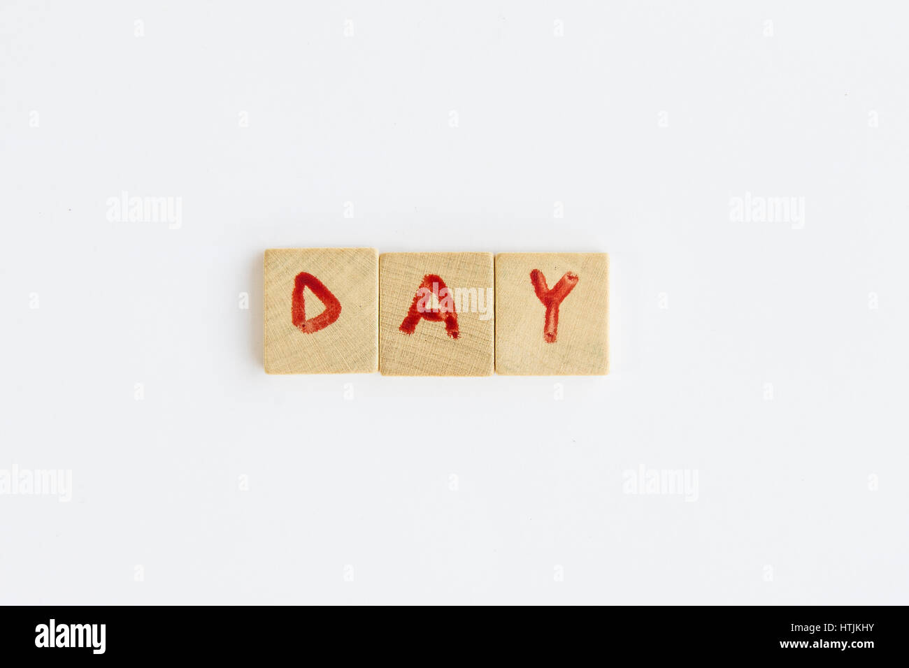 the word Day formed with letters written on squares of wood dowels ...