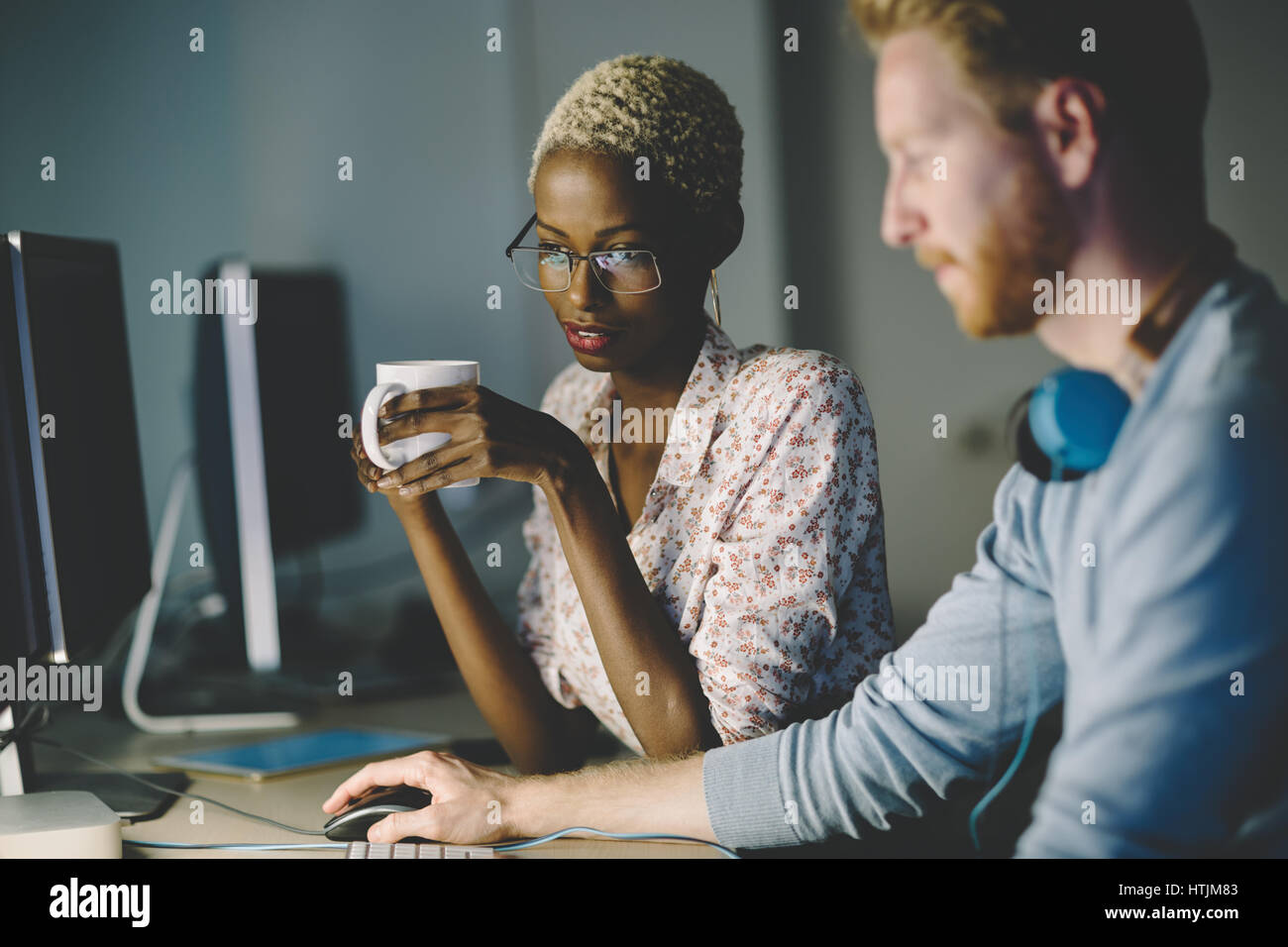 Programmers and business people collaborating in company office Stock Photo - Alamy