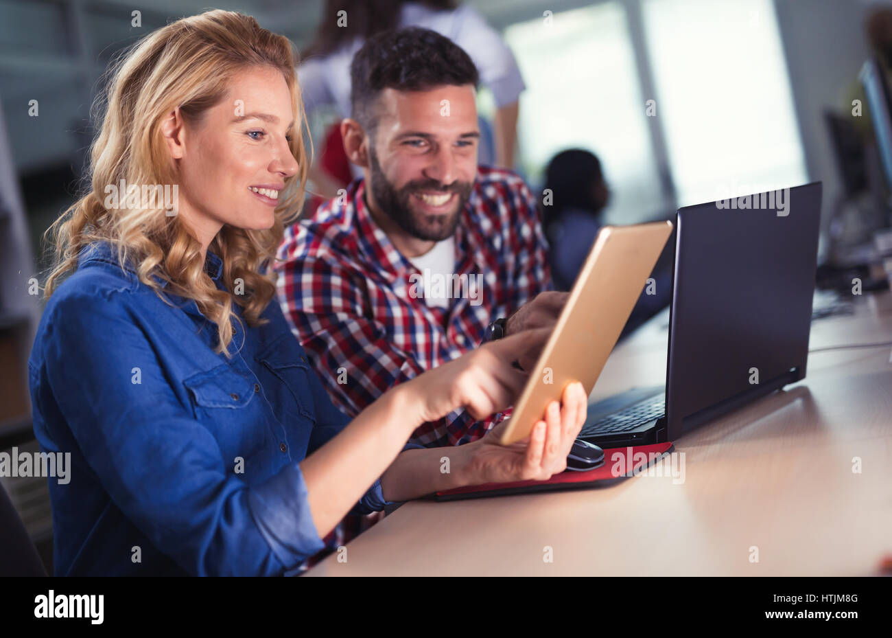 Programmers and business people collaborating in company office Stock Photo - Alamy