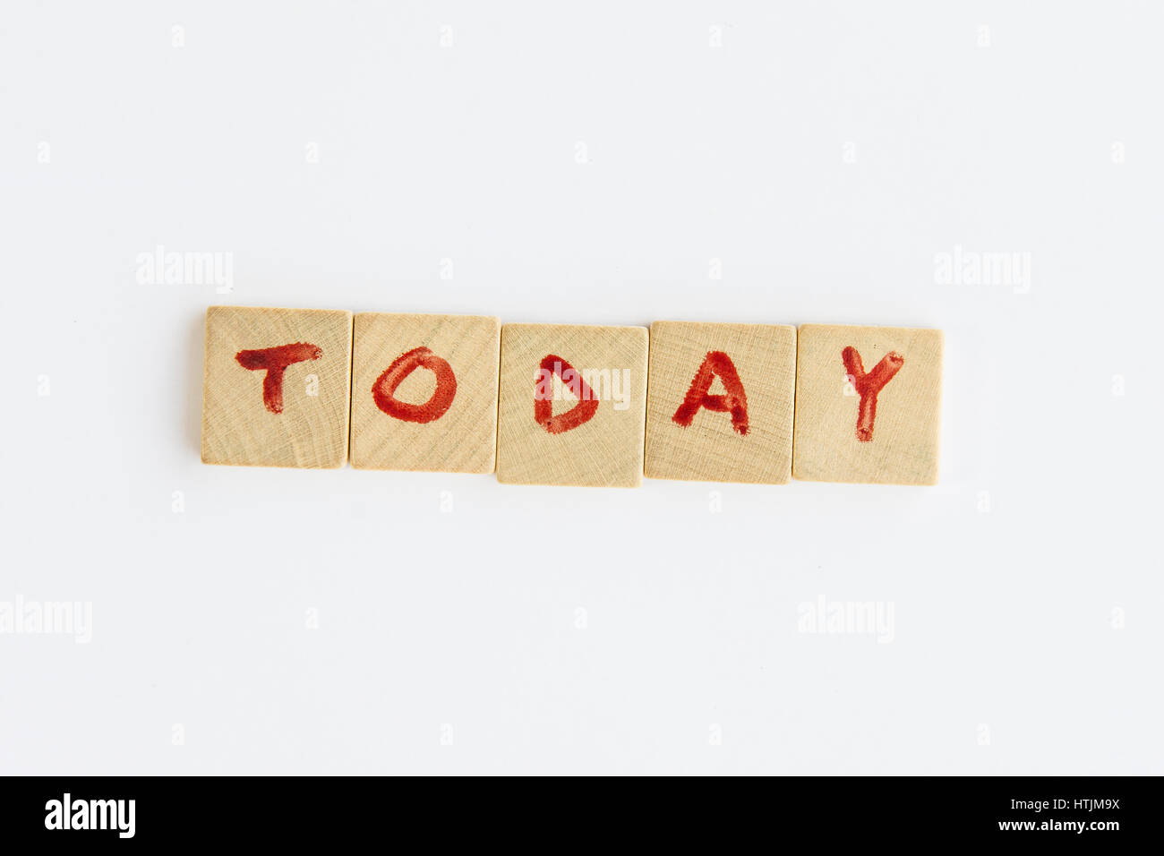 the word Today formed with letters written on squares of wood dowels ...