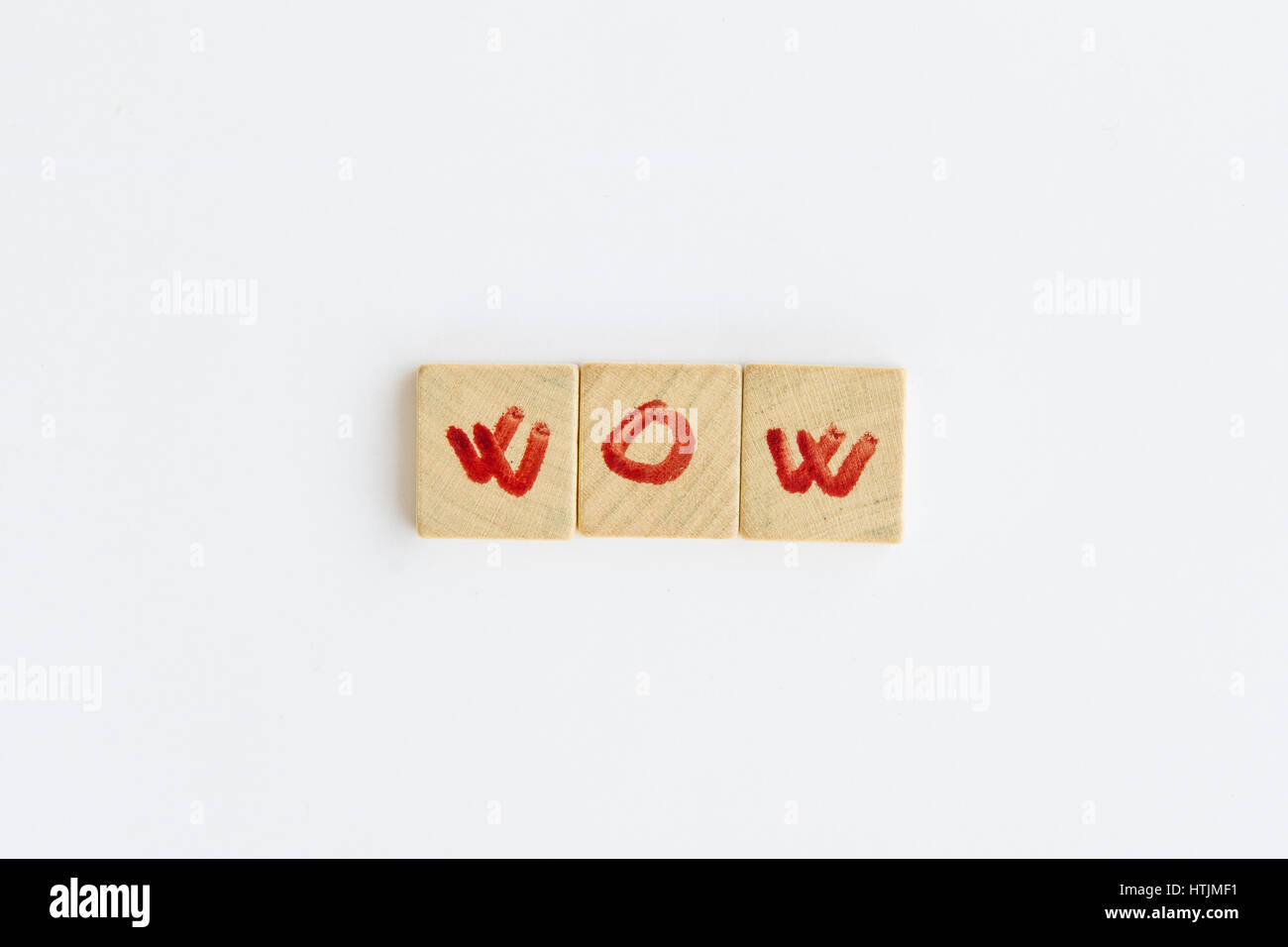 the word Wow formed with letters written on squares of wood dowels ...