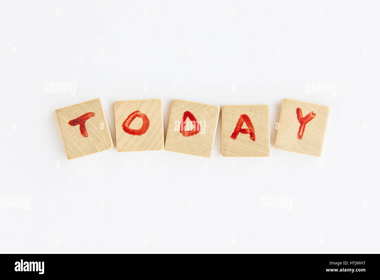 the word Today formed with letters written on squares of wood dowels ...