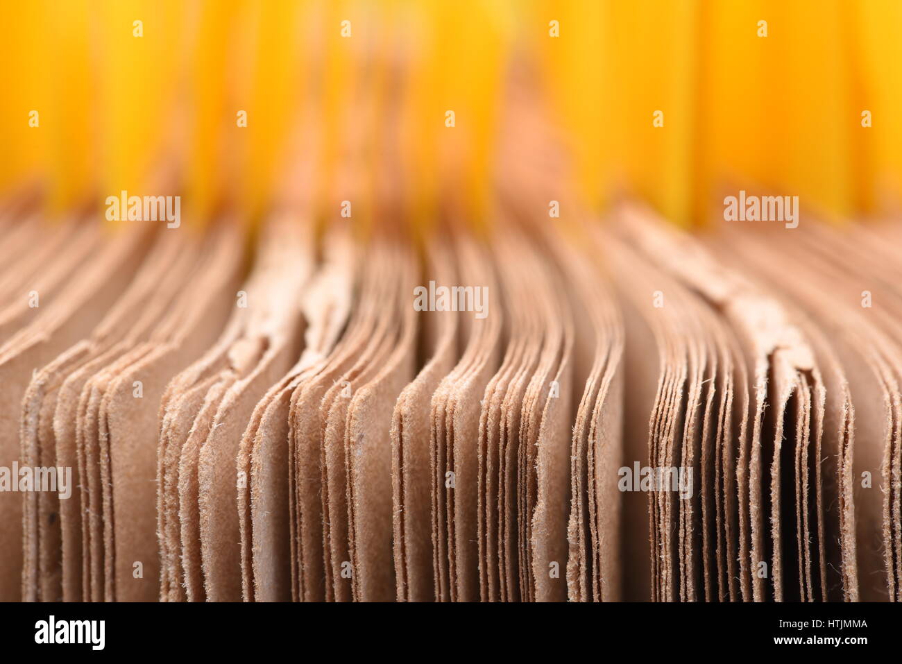 Old book pages closeup with yellow blurred background Stock Photo - Alamy