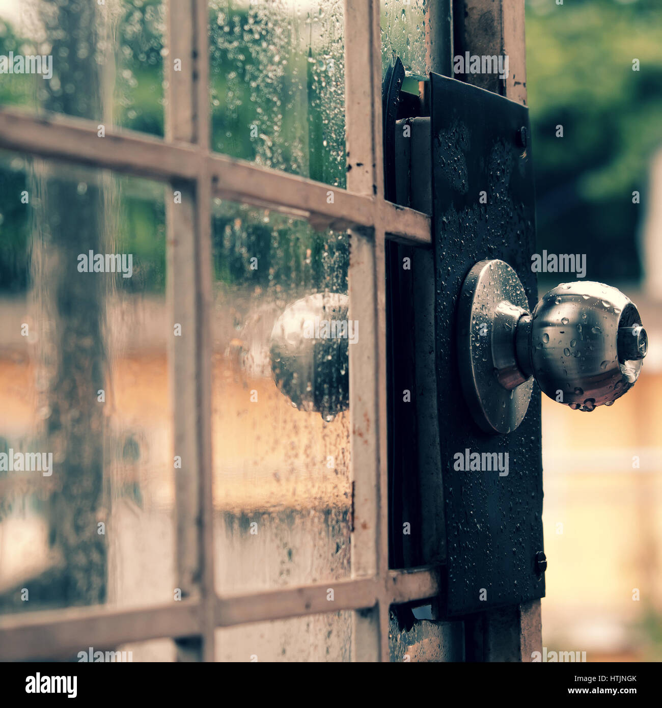 Rain drops on door handle and glass window in rainy day, drop of water ...