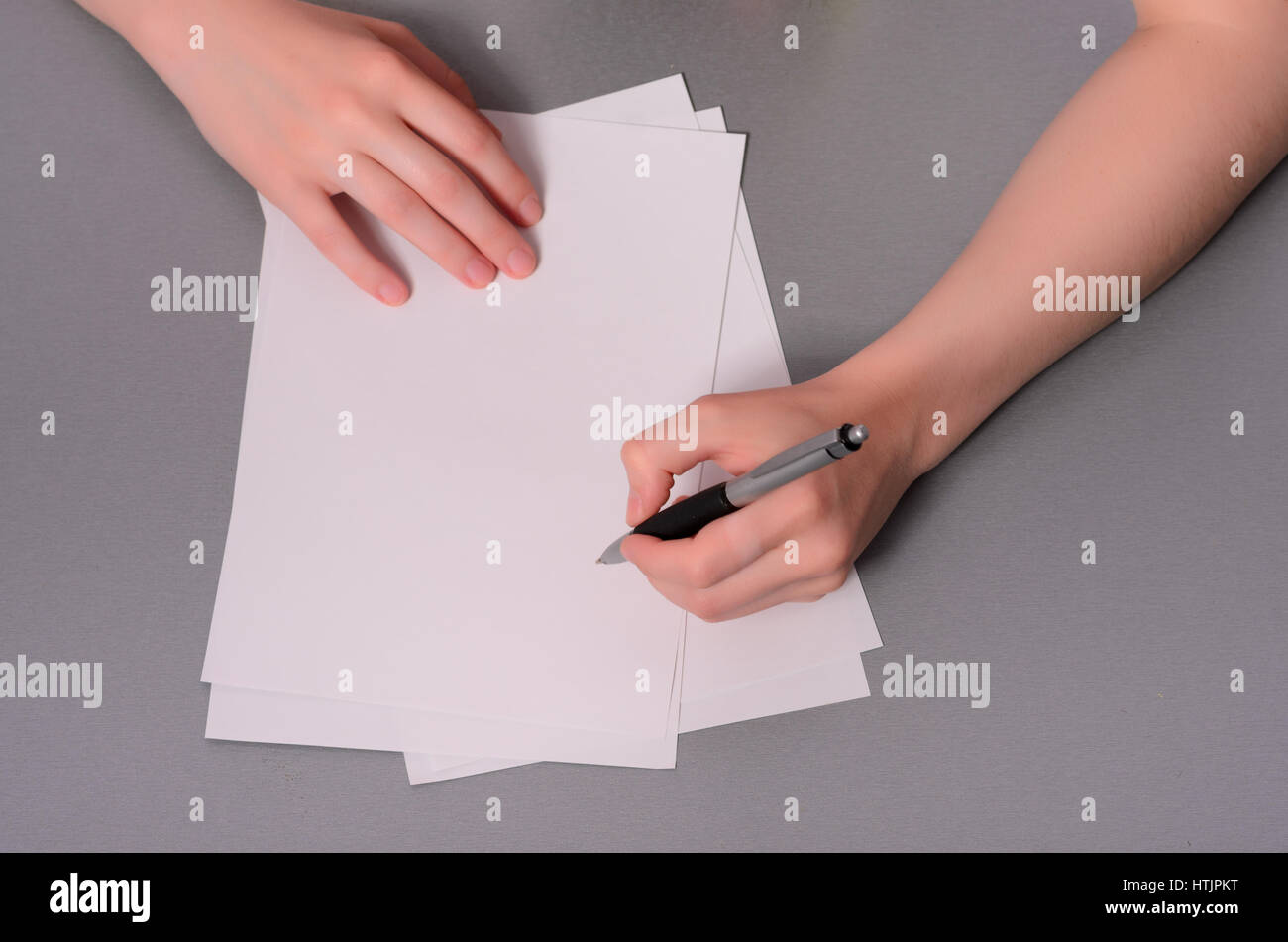 Human hands with pencil writing on paper and erase rubber on wooden ...