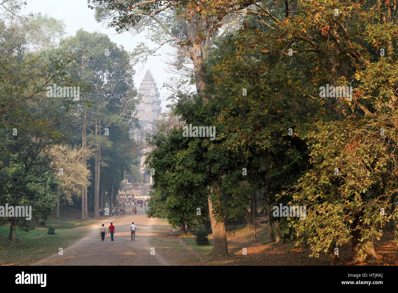 Tourists walk up the path from the eastern gate towards the temple of ...