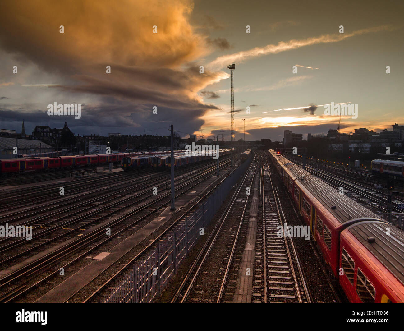 London: Dramatic skies over Clapham Junction station as trains arrive ...