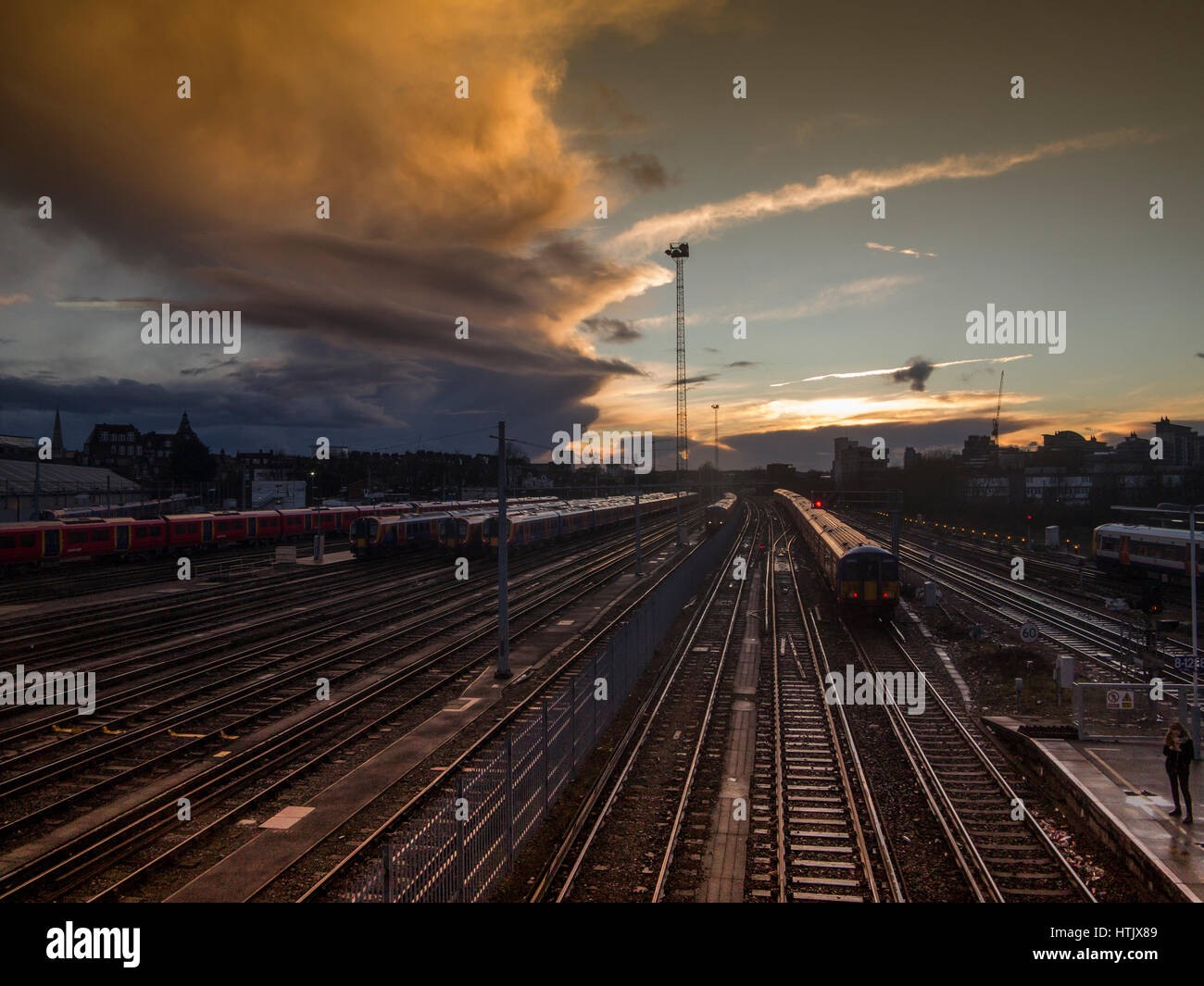 London: Dramatic skies over Clapham Junction station as trains arrive ...