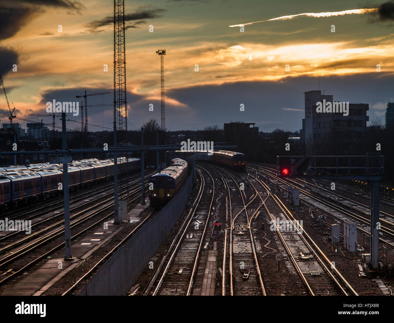 London: Dramatic skies over Clapham Junction station as trains arrive ...