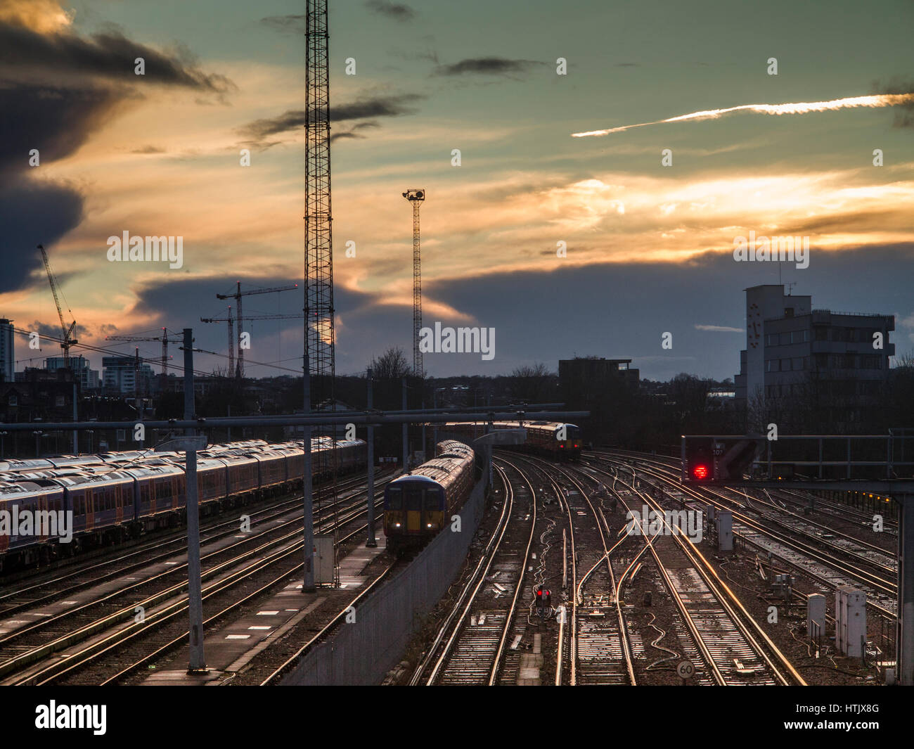 London: Dramatic skies over Clapham Junction station as trains arrive ...