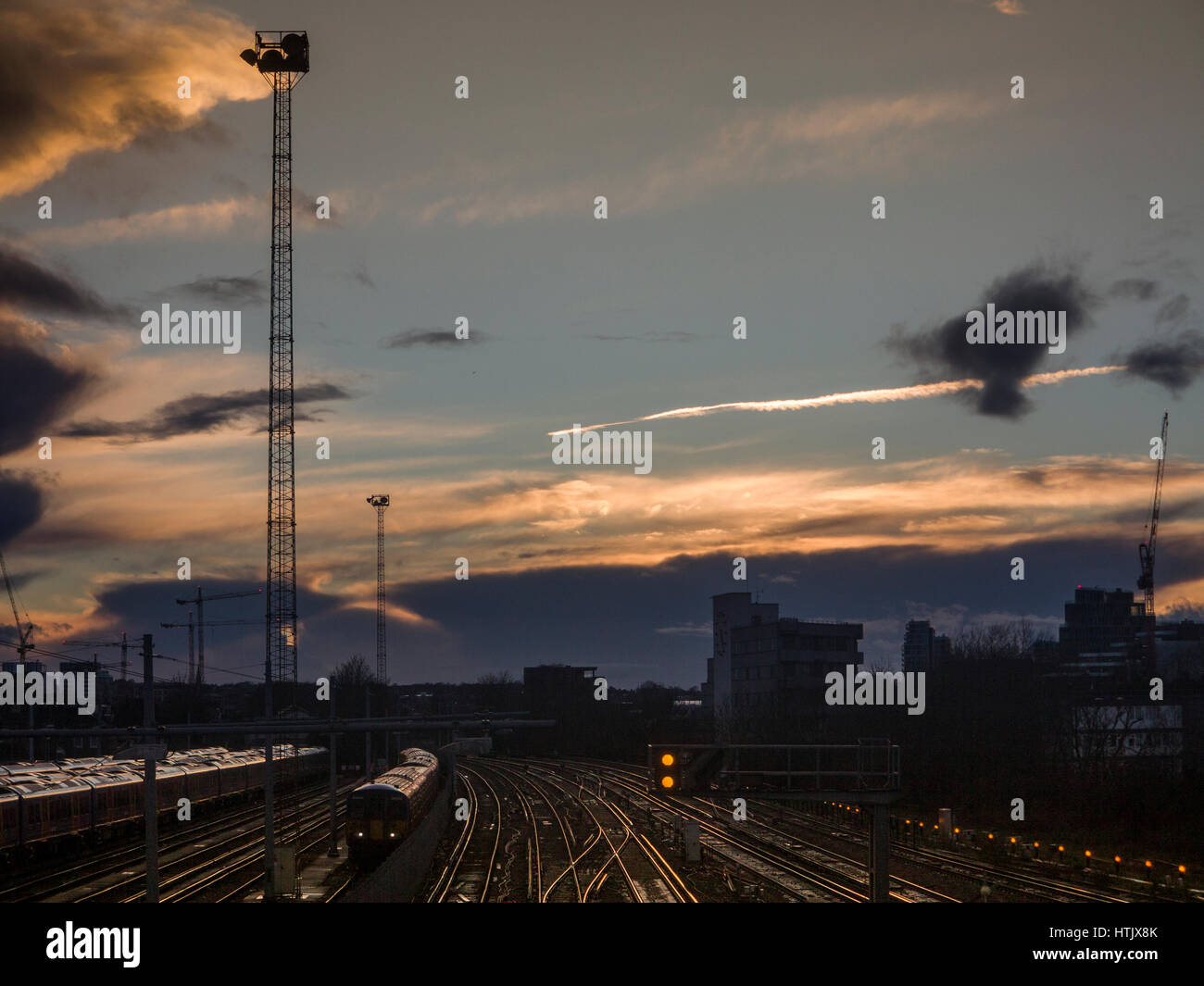 London: Dramatic skies over Clapham Junction station as trains arrive ...