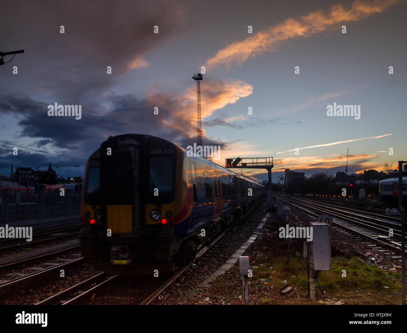 London: Dramatic skies over Clapham Junction station as trains arrive ...