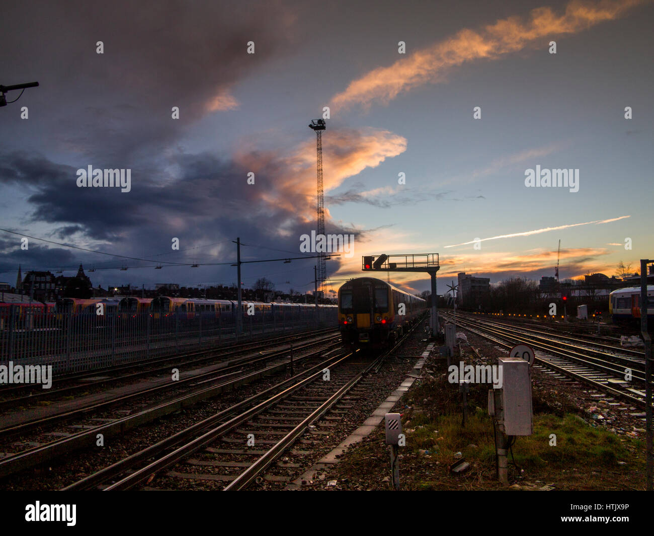London: Dramatic skies over Clapham Junction station as trains arrive ...