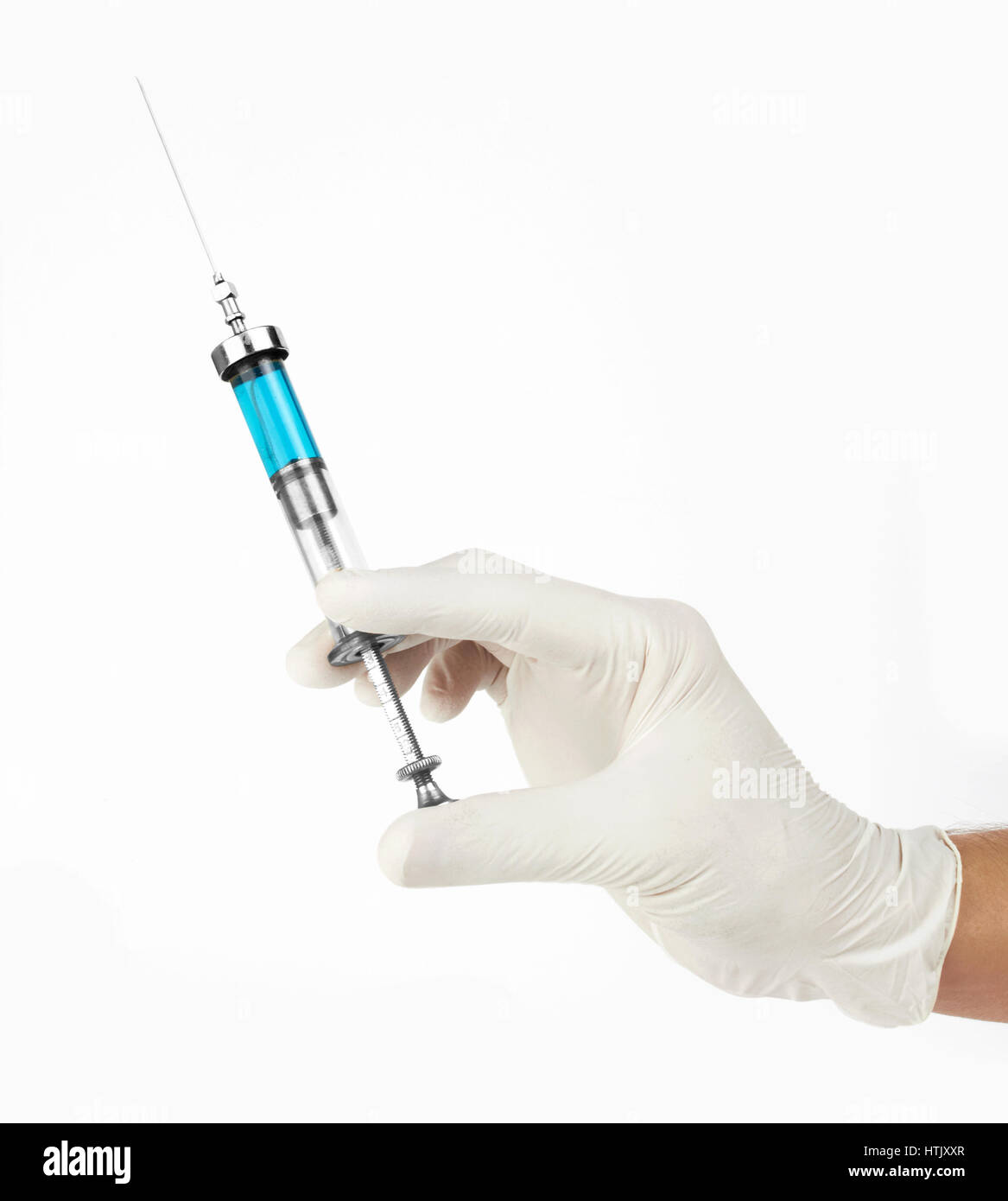 Hand holding an old-fashioned glass syringe Stock Photo - Alamy