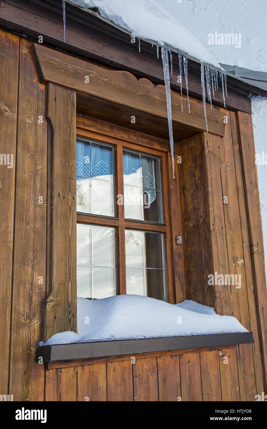 Window with icicles hanging down, snow on the window sill, and snow ...