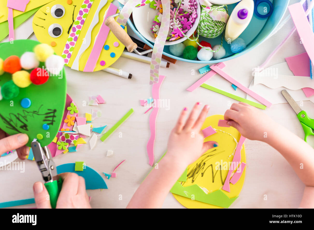 Step by step. Mother and daughter decorating paper Easter eggs Stock ...