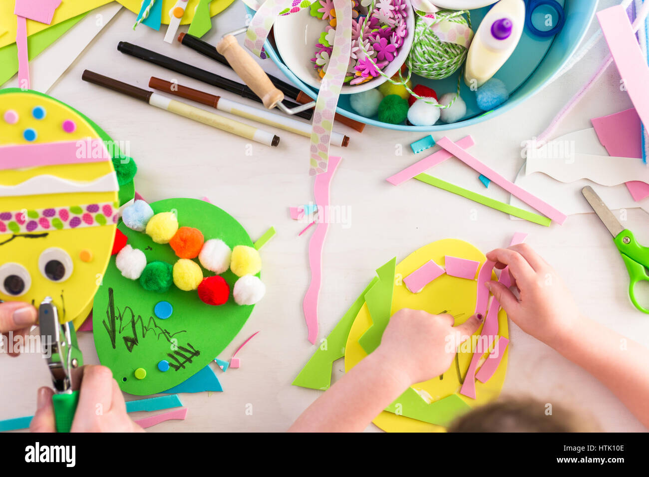 Step by step. Mother and daughter decorating paper Easter eggs Stock ...