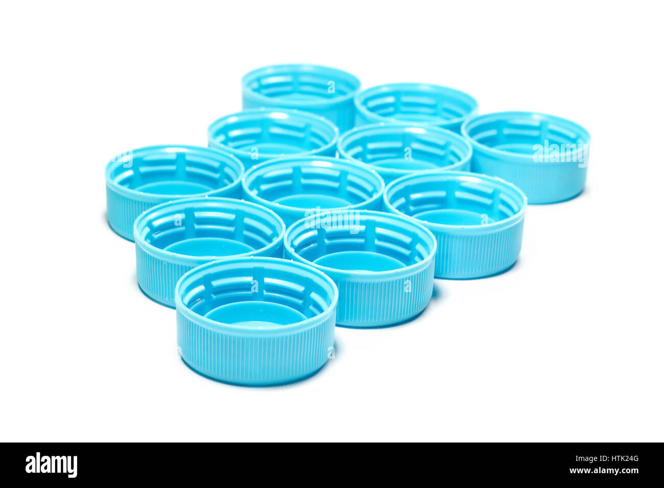 Light blue plastic bottle caps isolated on white background Stock Photo ...