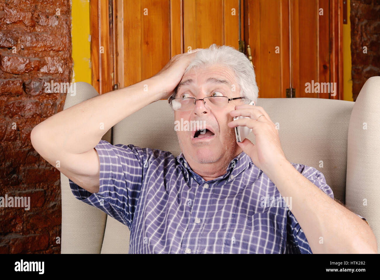 Portrait of an old man talking on the phone. Indoors Stock Photo - Alamy