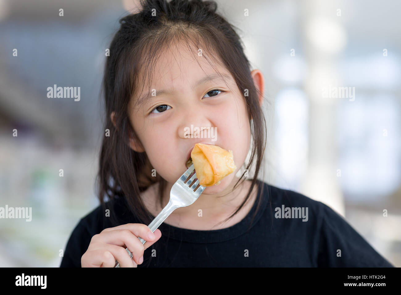 Cute Asian kid enjoy eating food, fried spring roll Stock Photo - Alamy