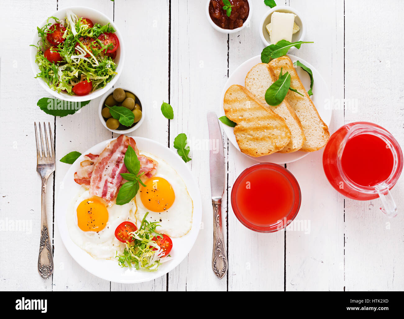 English breakfast - fried egg, tomatoes and bacon. Flat lay. Top view ...