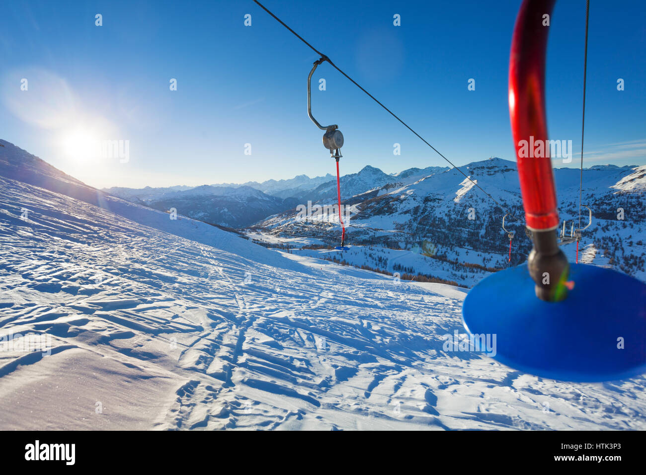 Close-up picture of empty blue button lift against beautiful mountain ...