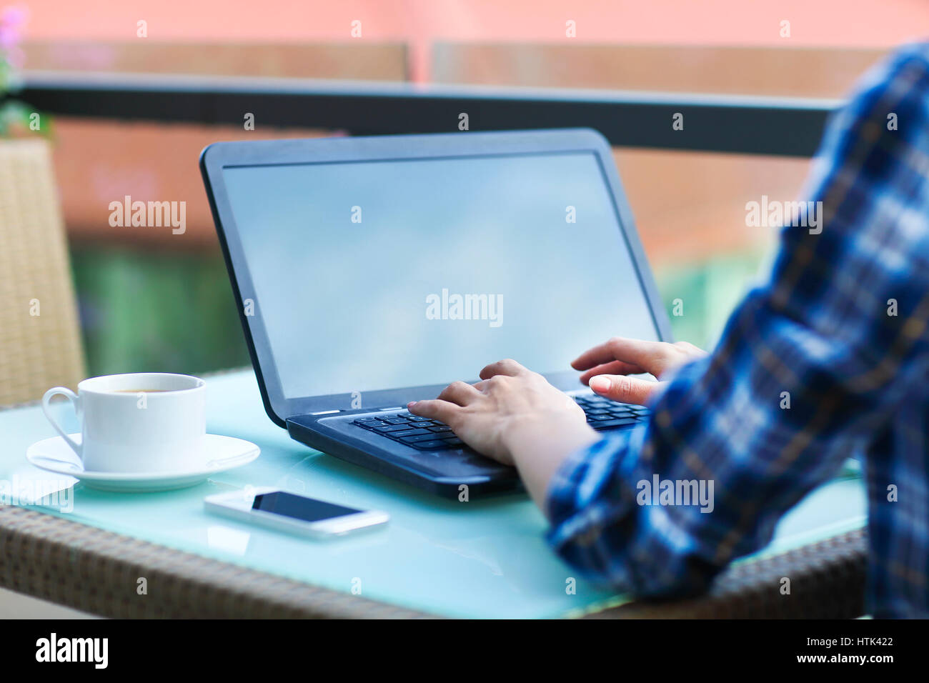 Young freelancer woman using laptop computer sitting at cafe table ...