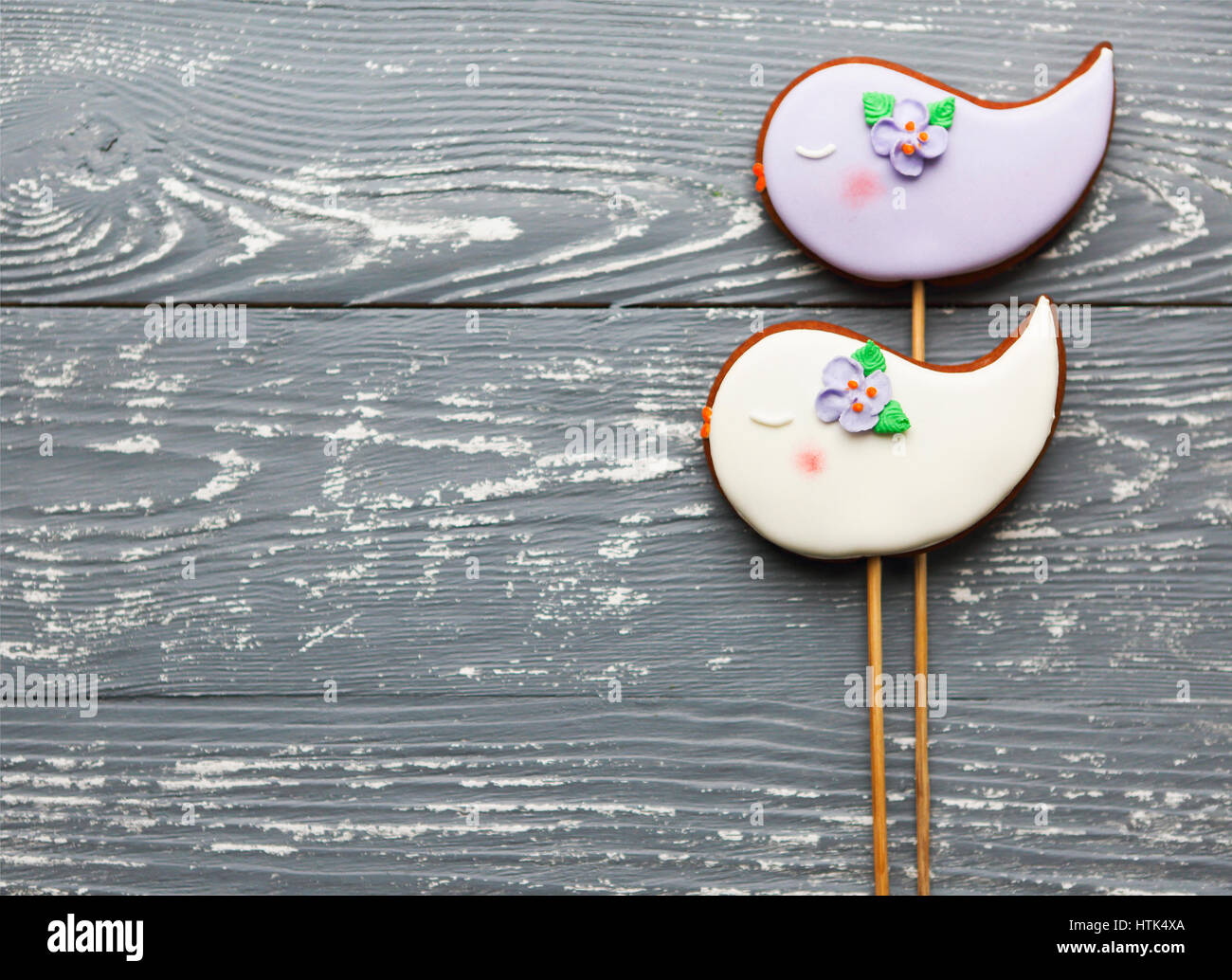 Violet and white romantic cookies on a gray wooden background with copy ...