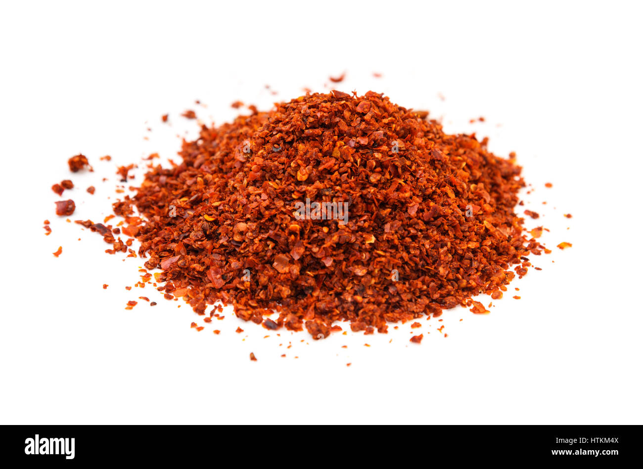 Pile of Aleppo Flakes red pepper isolated on white background selective ...