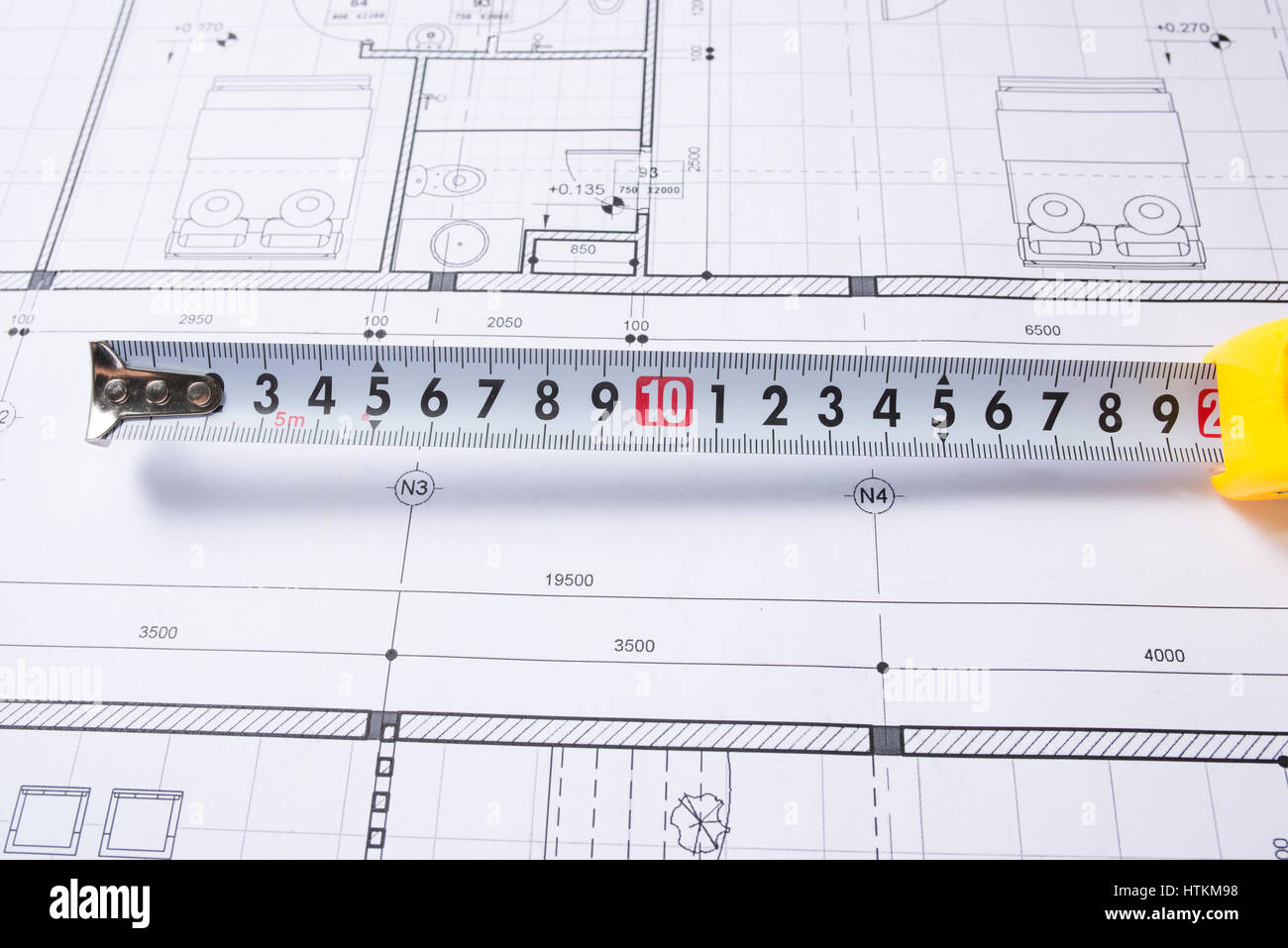 rolls of architectural house plans & tape measure Stock Photo - Alamy