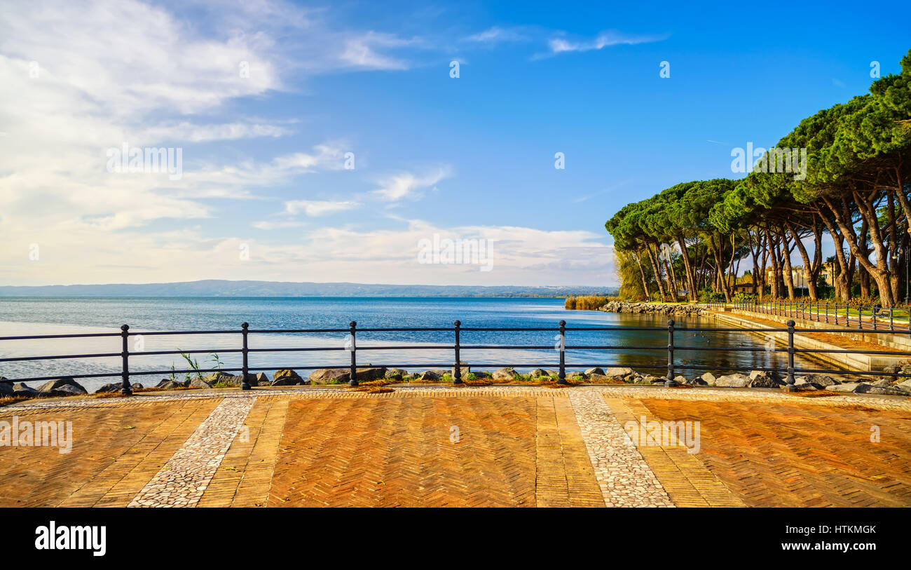 Terrace, promenade or esplanade and pine trees in Bolsena lake, Italy ...