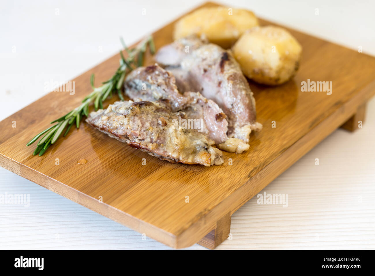 Oven cooked lamb with potatoes on board Stock Photo - Alamy