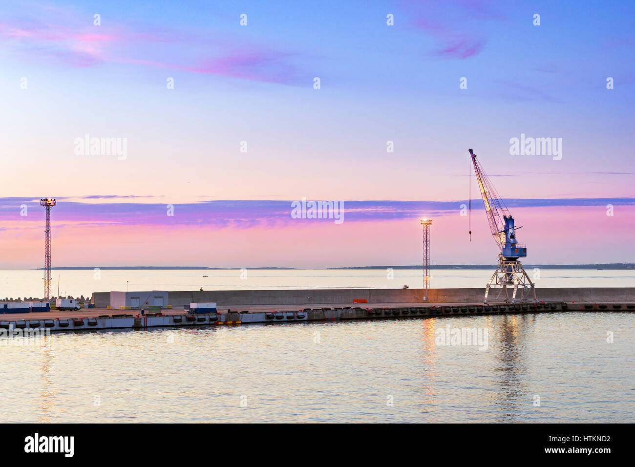Multi-ton industrial port crane on rails lifts heavy loads in marine ...
