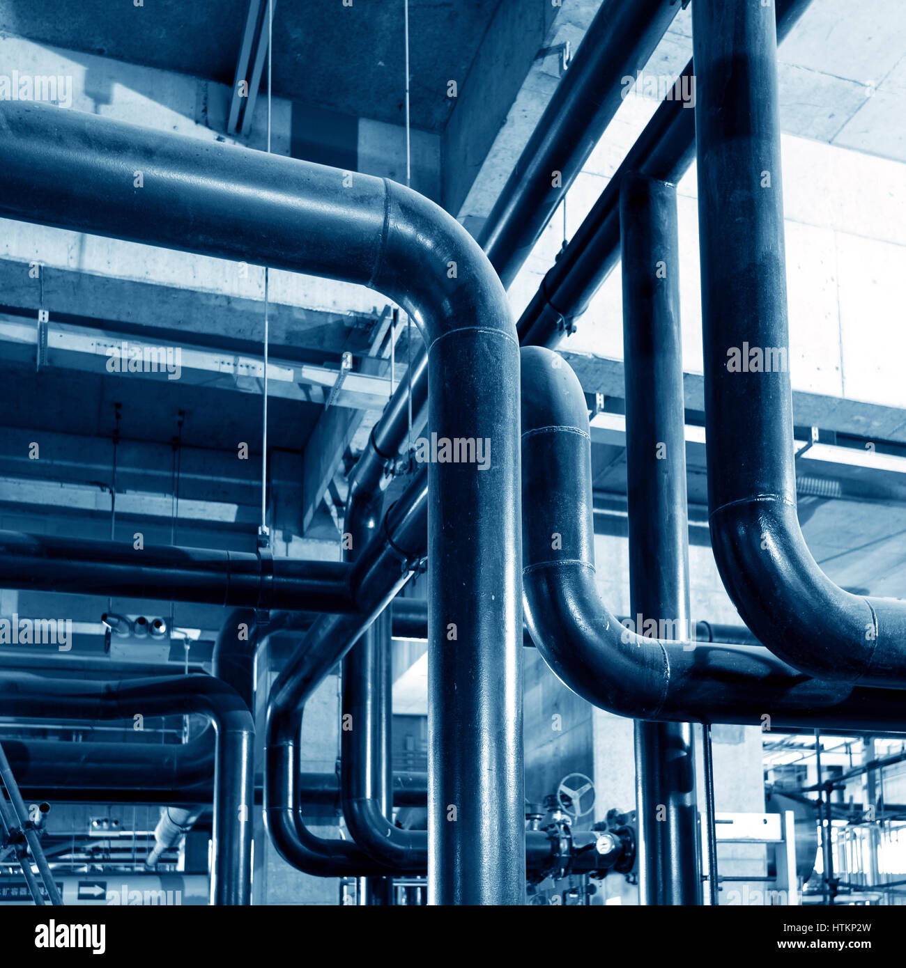 Equipment, cables and piping as found inside of industrial power plant ...