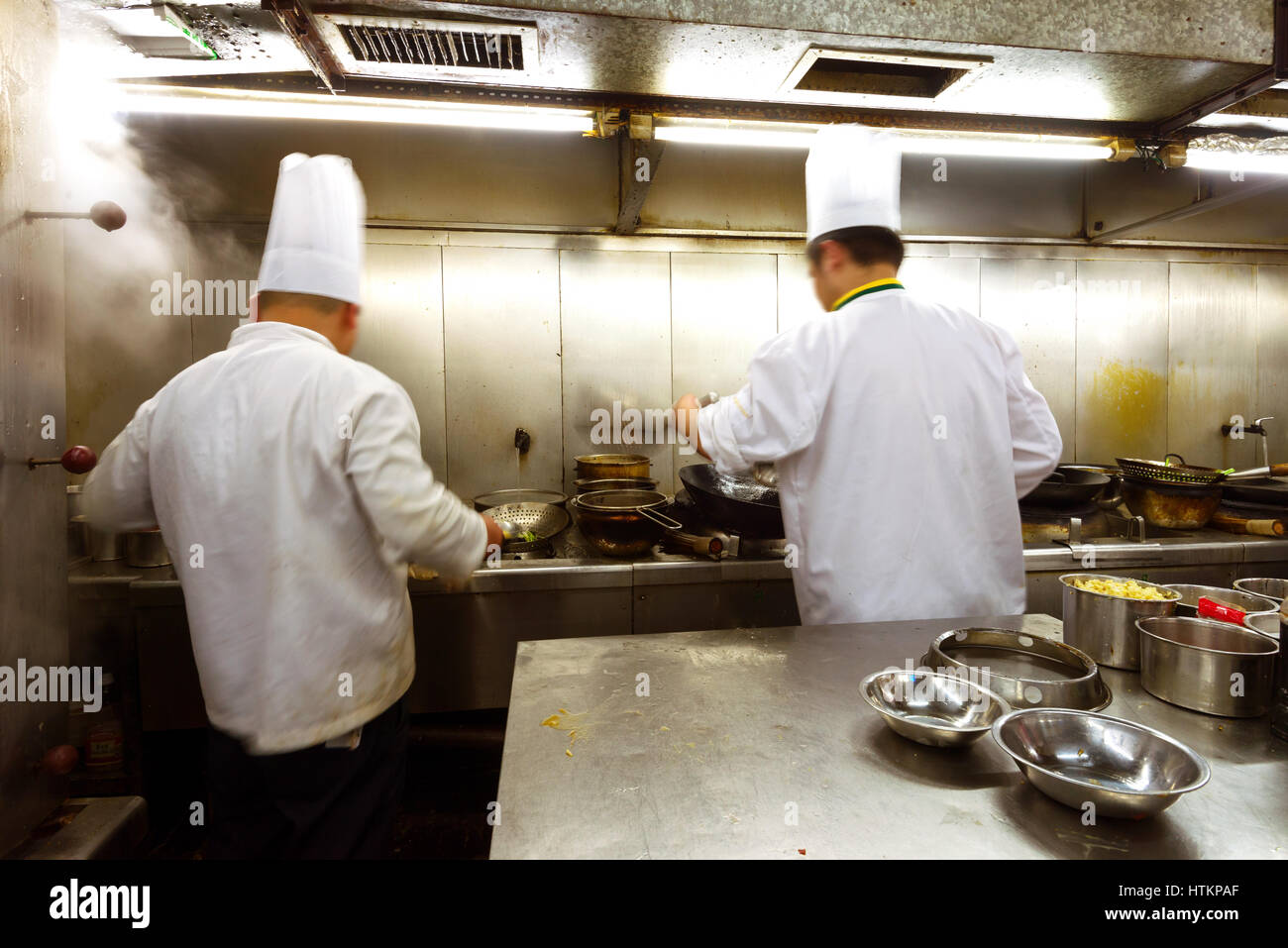 Crowded kitchen, a narrow aisle, working chef Stock Photo - Alamy