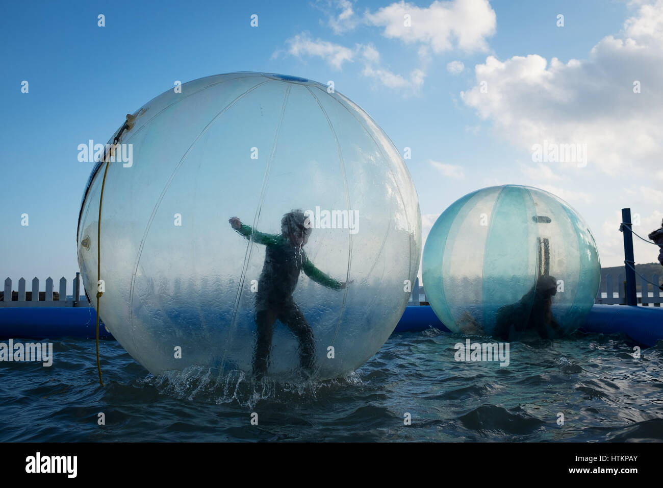 Silhouetted child in Transparent inflatable water ball Stock Photo - Alamy