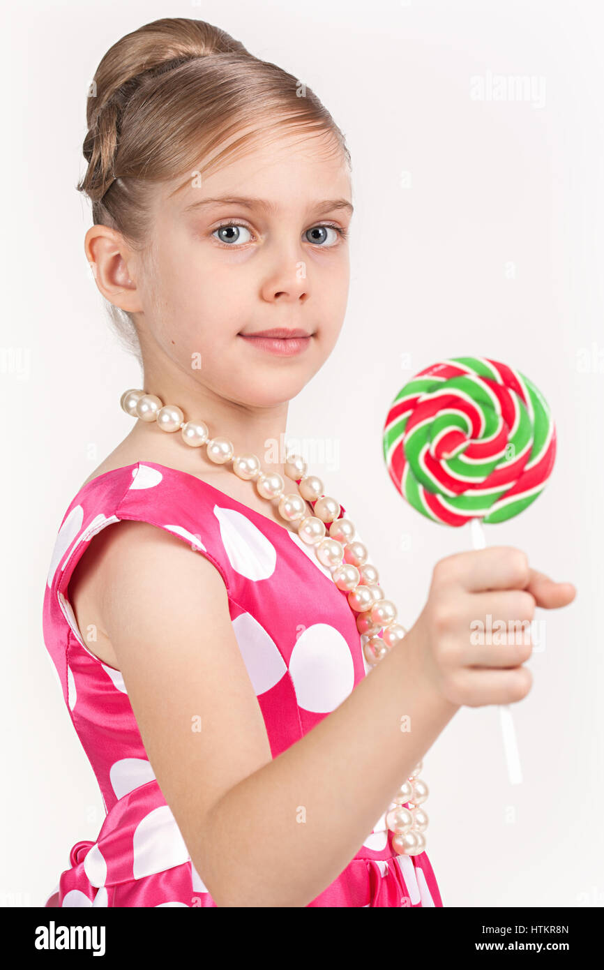 Girl shows a beautiful large candy Stock Photo - Alamy