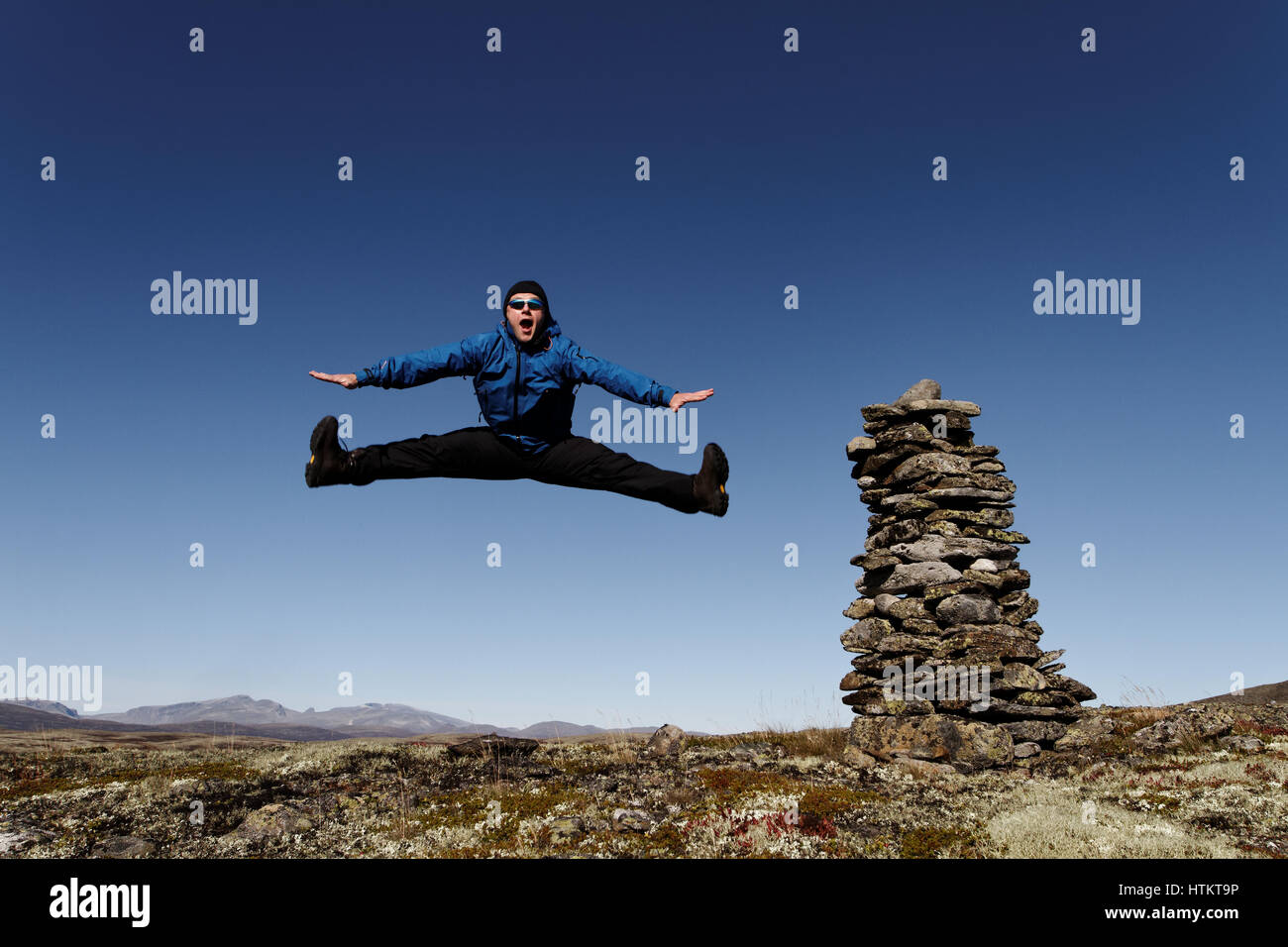 Man jumping in mountain landscape Stock Photo - Alamy