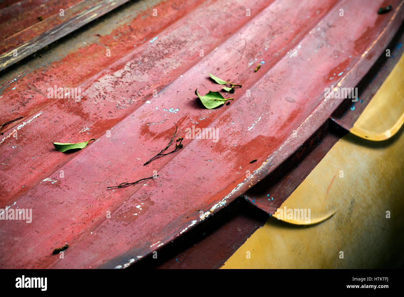 Coloured texture on ribbed hull of upturned boat showing abstract ...