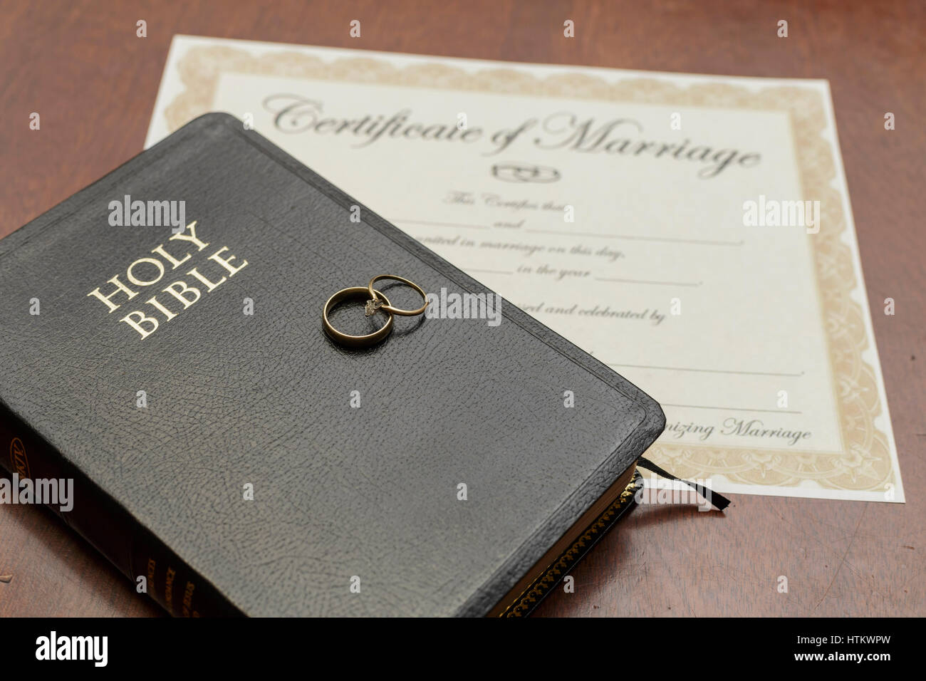 gold wedding rings with a bible and marriage certificate Stock Photo ...