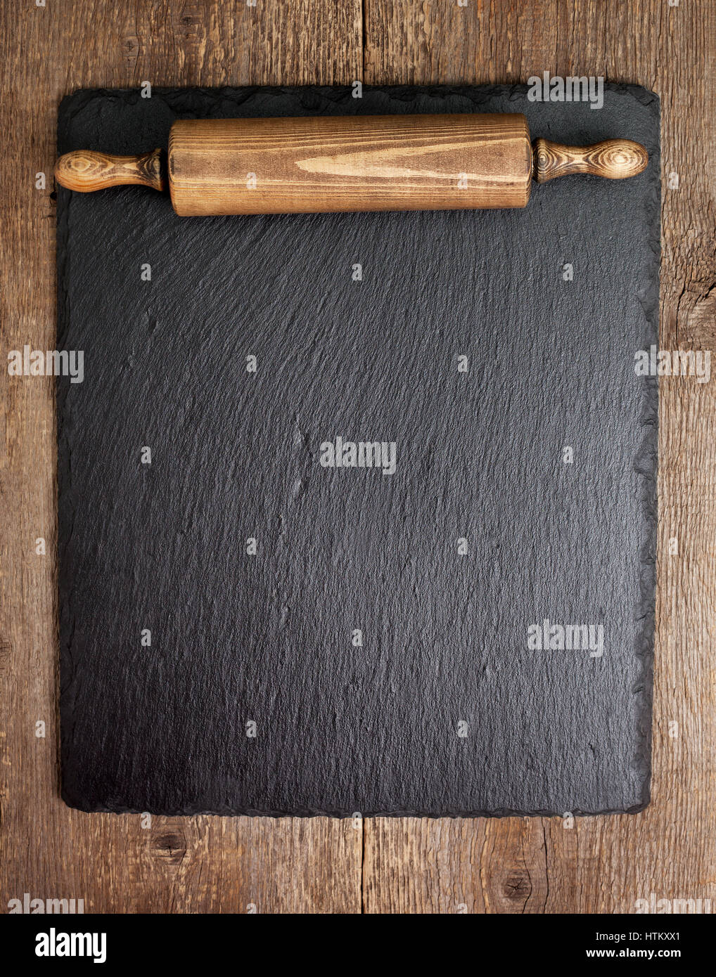 Black slate background with rolling pin. view from above, copy space ...