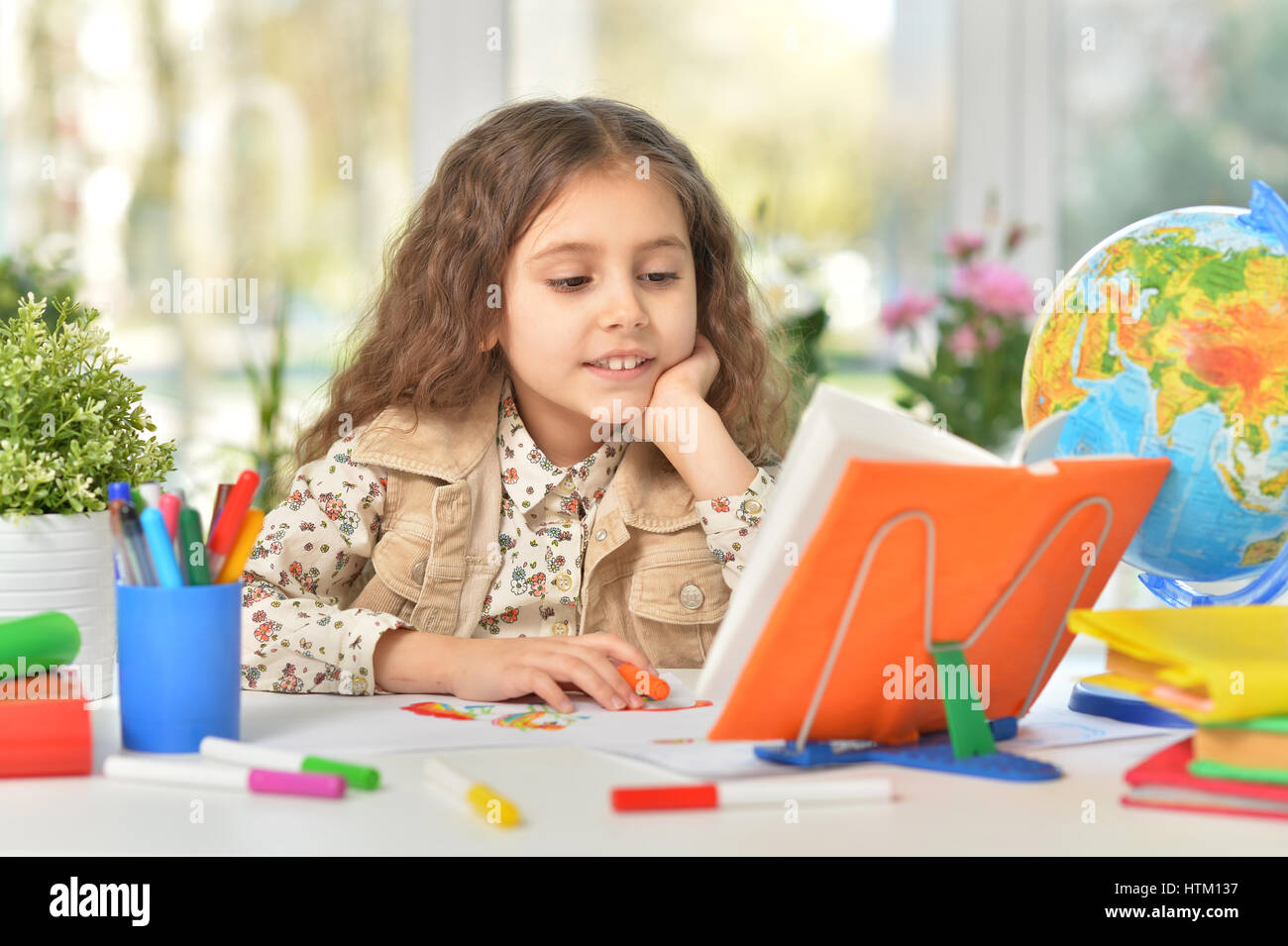 Portrait of a cute girl does lessons Stock Photo - Alamy
