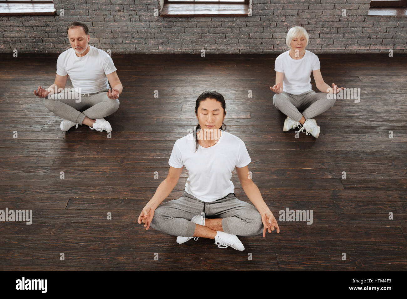 Group of people sitting with closed eyes Stock Photo - Alamy