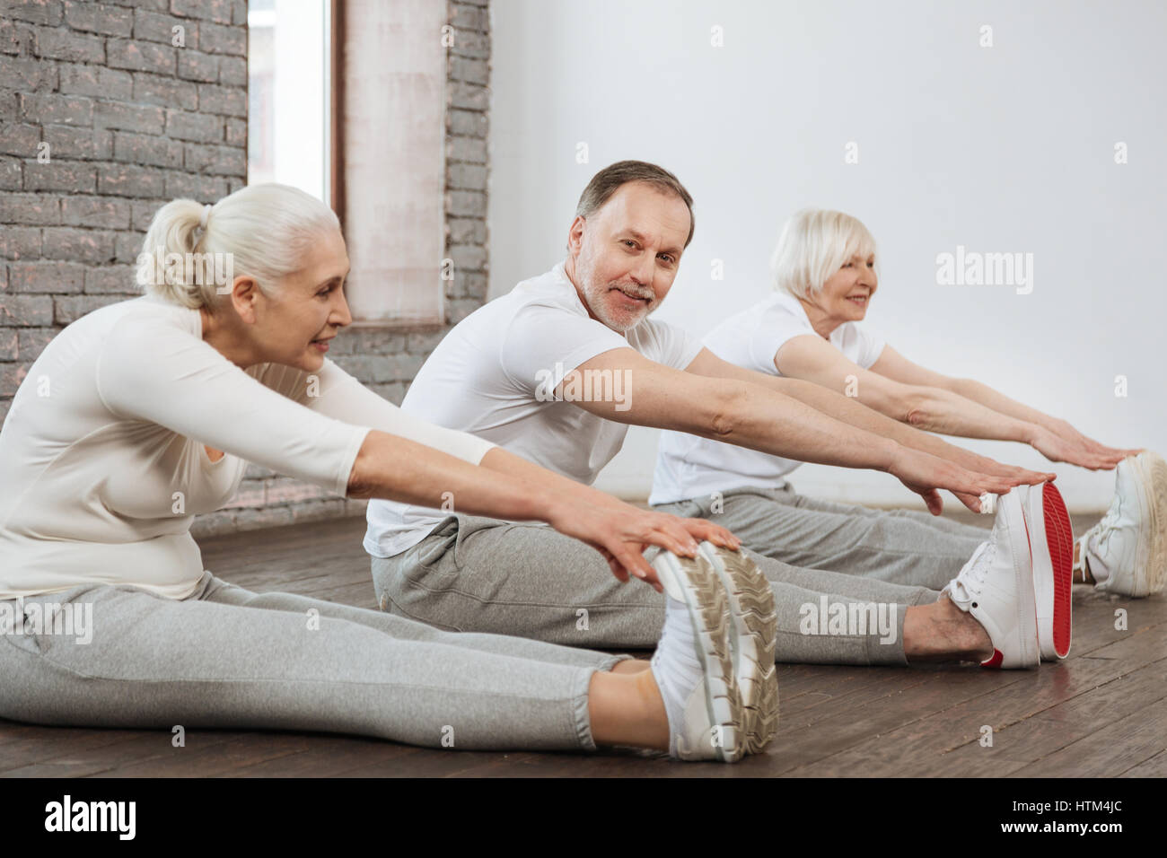 Positive delighted male stretching his back Stock Photo - Alamy