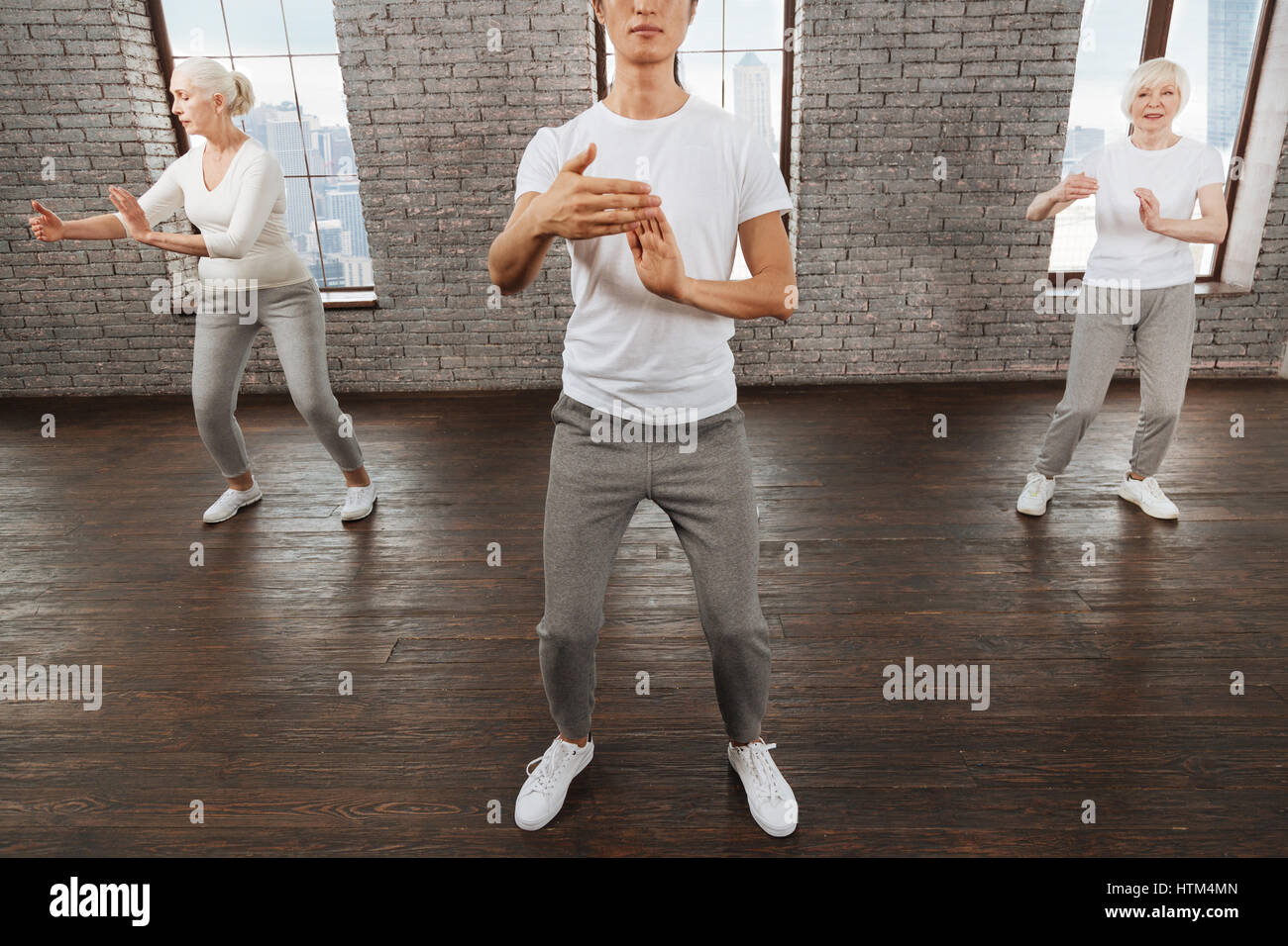 Two women repeating after their tutor Stock Photo - Alamy