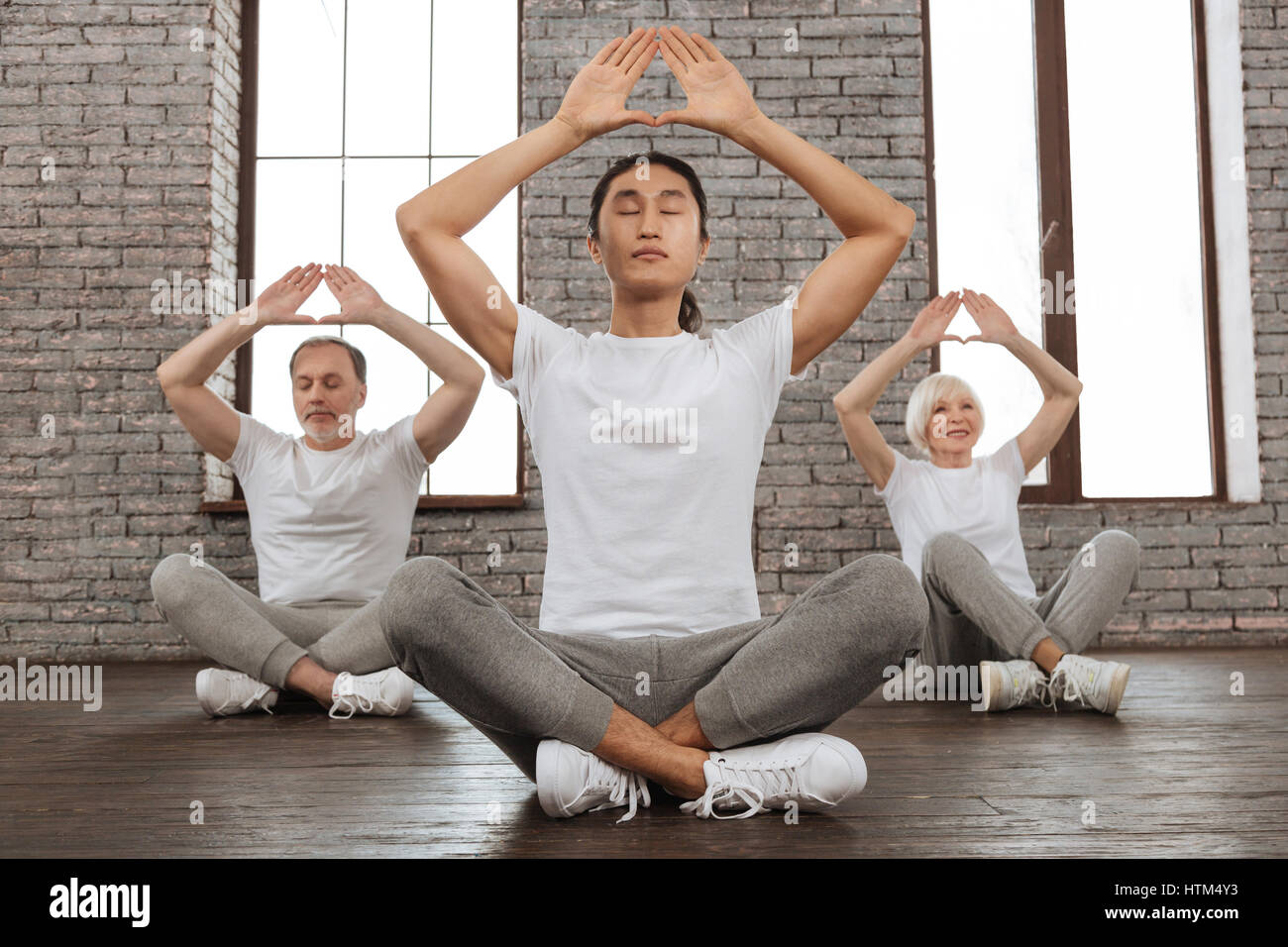 Three people doing yoga poses Stock Photo - Alamy