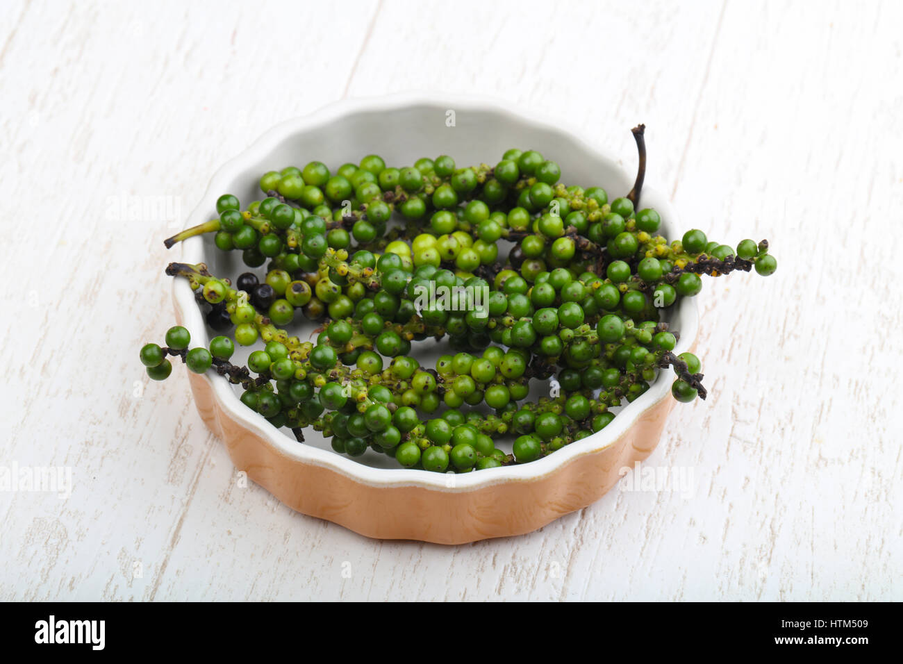 Green pepper corn on the branch in plate Stock Photo - Alamy