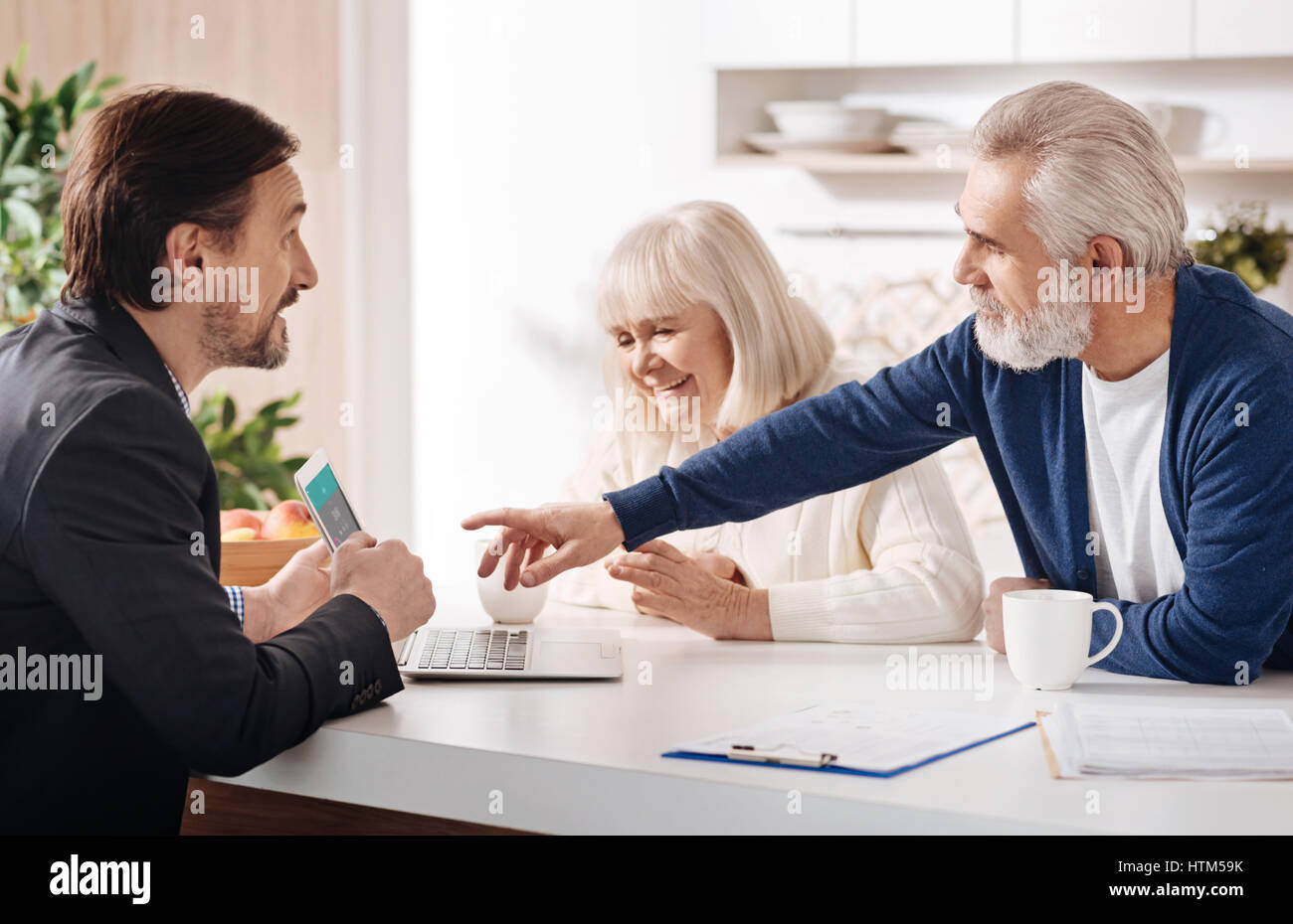 Finance advisor meeting with elderly couple of clients Stock Photo - Alamy