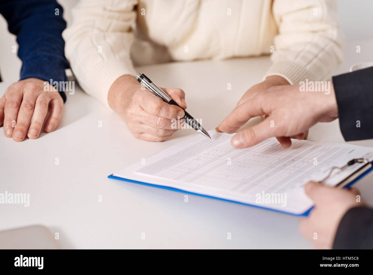 Senior couple signing important document at home Stock Photo - Alamy